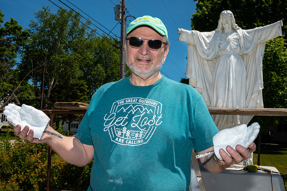 Artist casts his own hands in restoration of Wisconsin parish's statue ...